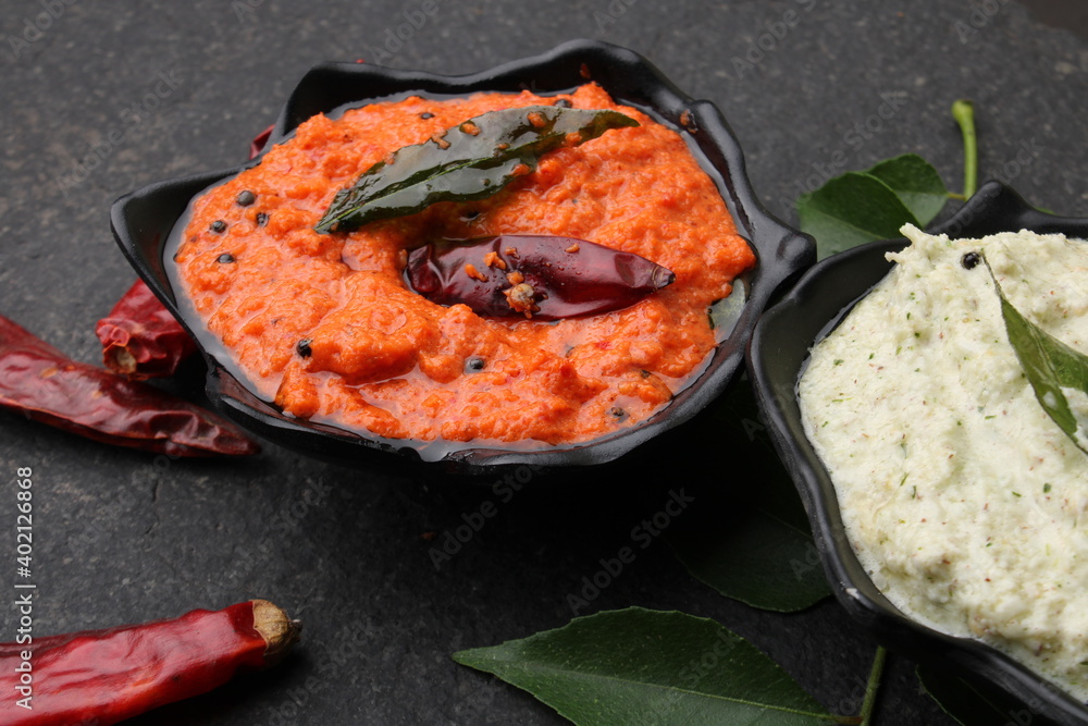 Variety of South Indian Chutney like coconut, tomato served in bowls ...