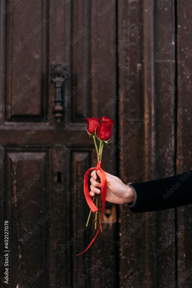 hand holding red roses bouquet Stock Photo | Adobe Stock