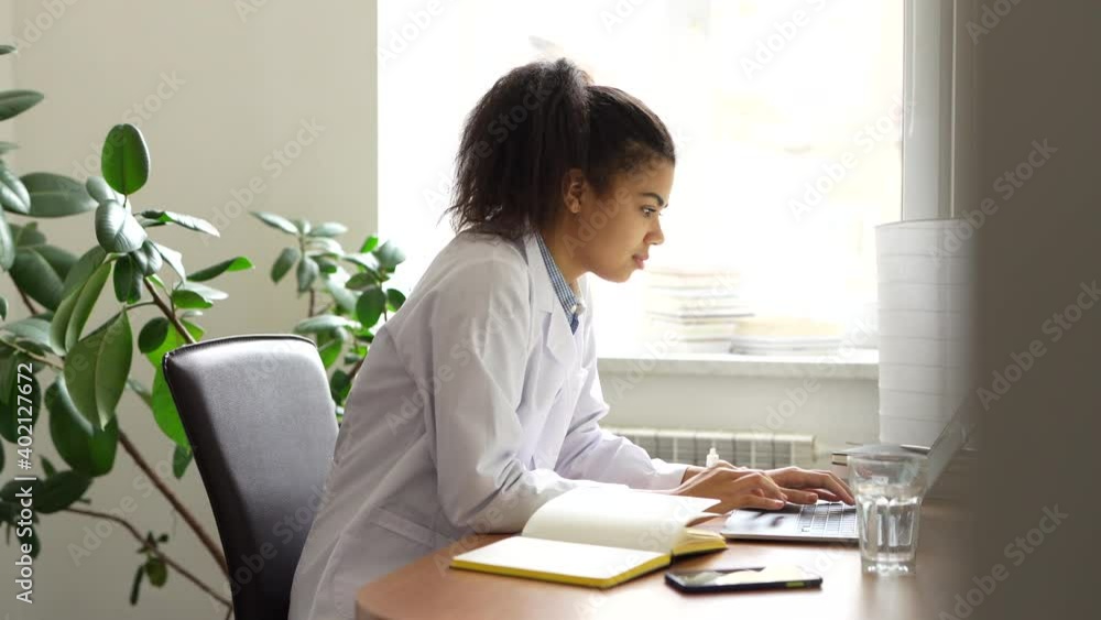 Internship. Enthusiastic young female medical student typing while ...