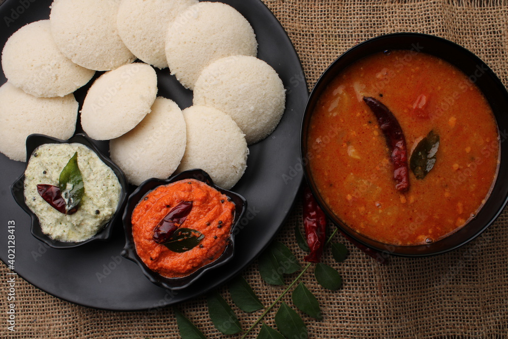 Idly sambar or Idli with Sambhar and green, red chutney. Popular South ...