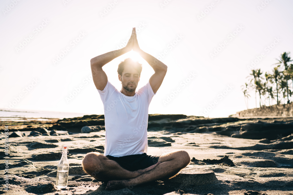 Concentrated man doing Lotus pose with Namaskar Mudra gesture under ...