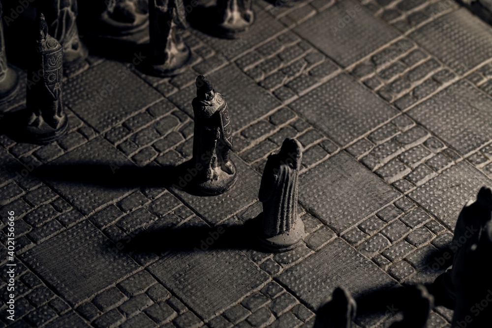 A portrait of two soldier pieces of a game of chess facing each other ...