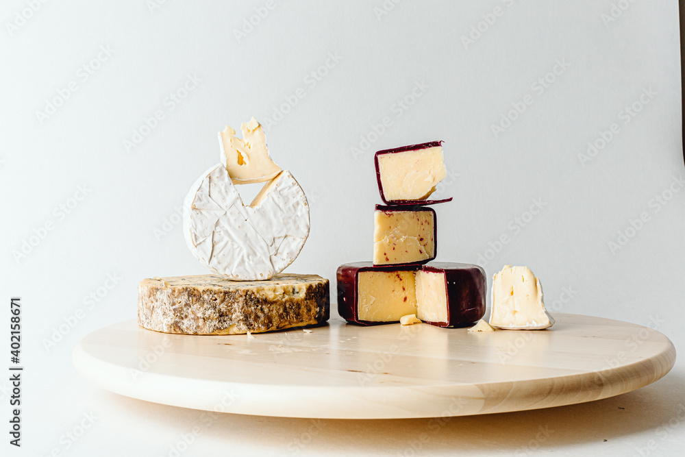 Assortment of different cheese types on dark and white background ...
