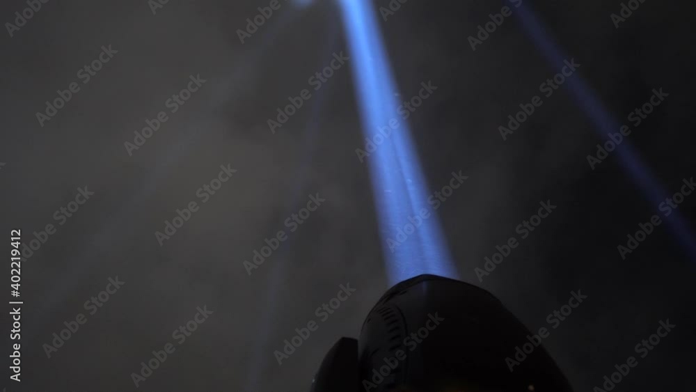 Close up on the searchlight at night. The light is very strong and ...