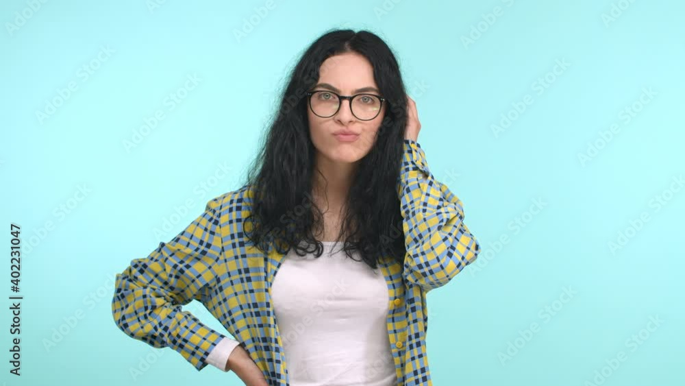 Troubled pretty woman standing pensive, scratching head and looking ...