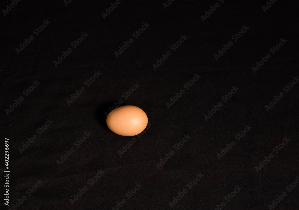 High angle shot and top view of a single egg isolated on black ...