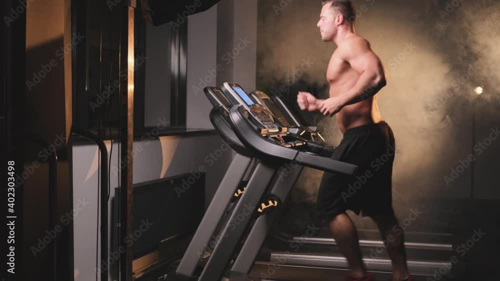 Muscular and shirtless athlete caring about his health doing physical ...