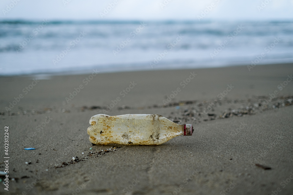 Dirty Plastic bottle waste abbandoned on sea coast ecosystem ...