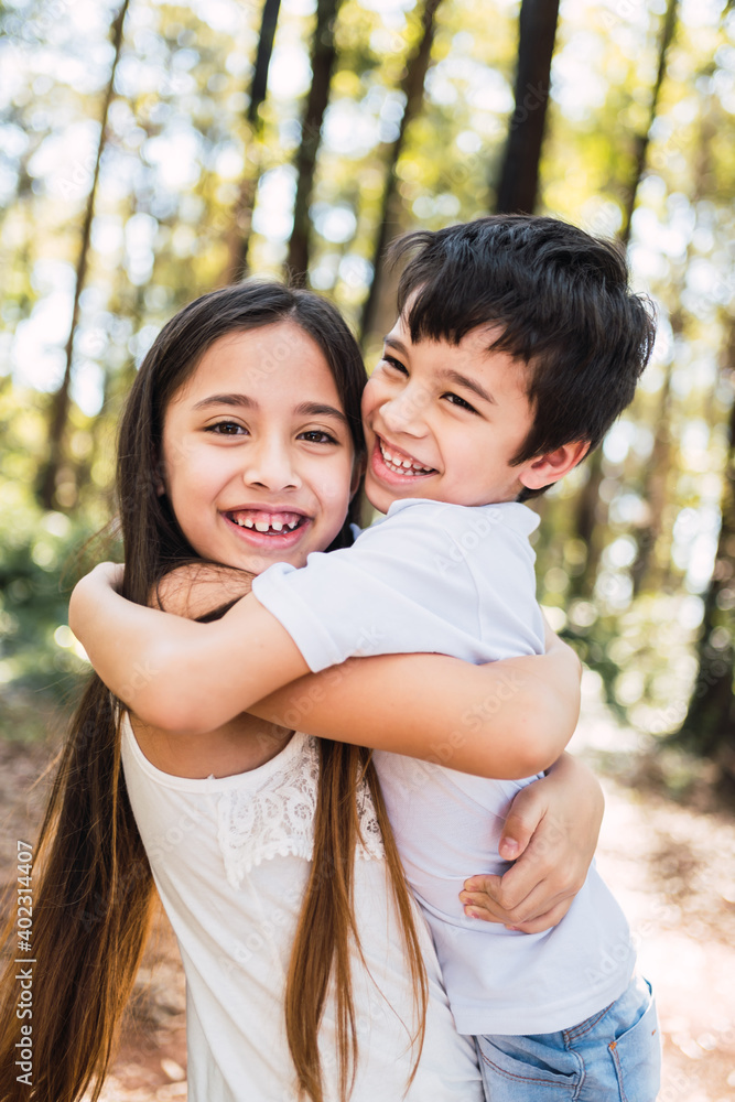Happy and adorable children hugging outdoors - Portrait of happy ...