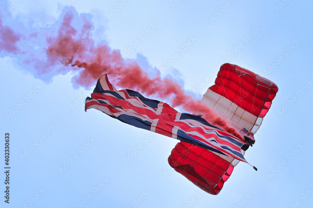 British Parachute Regiment parachutist descending to the ground with ...