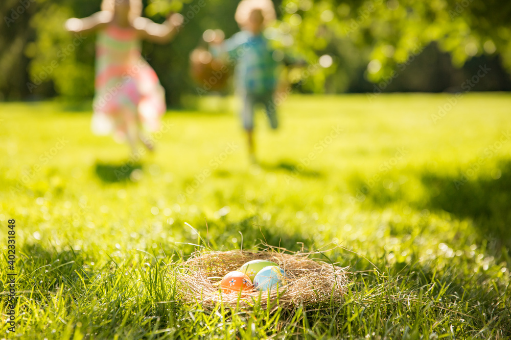 Cute boy and girl celebrating Easter, searching and eating chocolate ...
