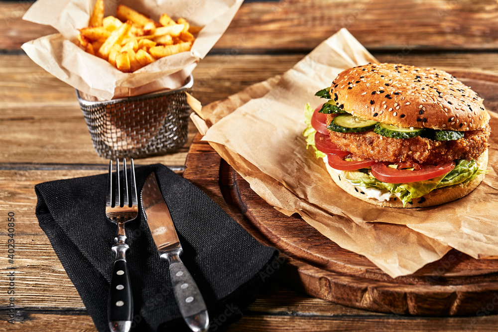 The concept of American fast food. A juicy American burger with two ...