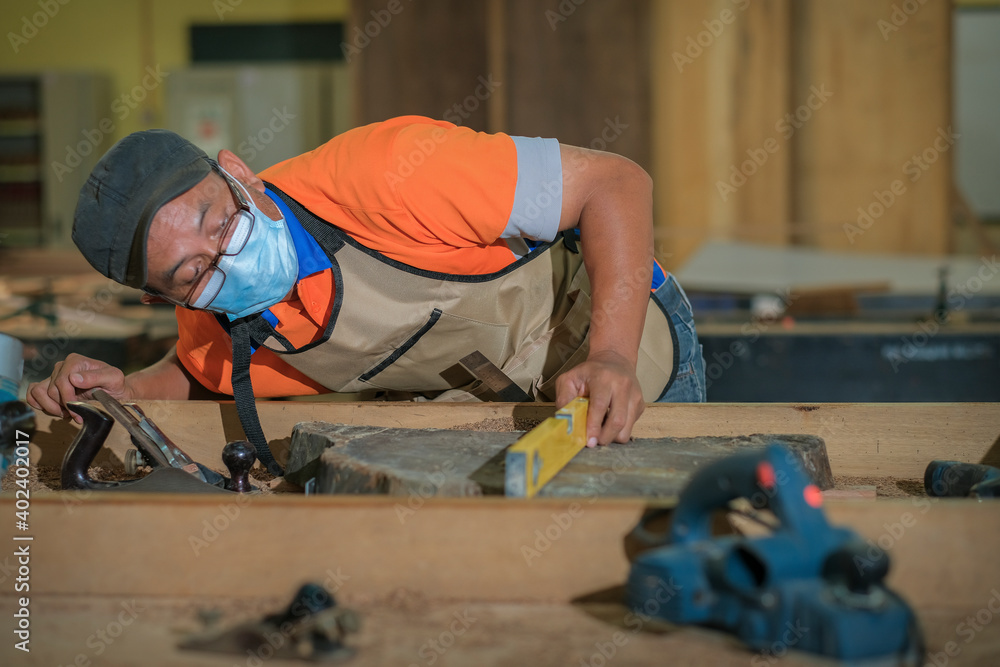 Front view photo of focused professional hardwood worker making slab ...