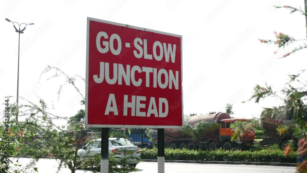 Traffic sign showing go slow junction a head, Traffic sign with ...