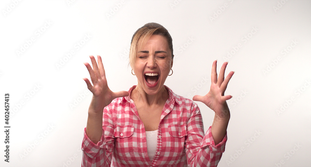 A young stressed blonde hair woman shouting isolated on white ...
