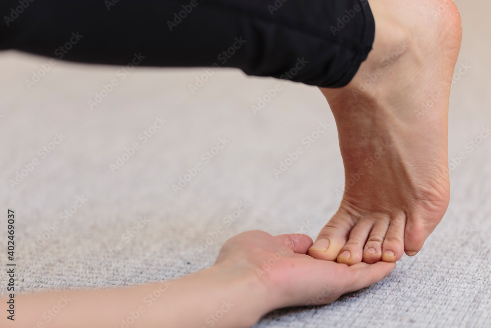 Horizontal detail of yogini wearing long dark yoga pants making ...