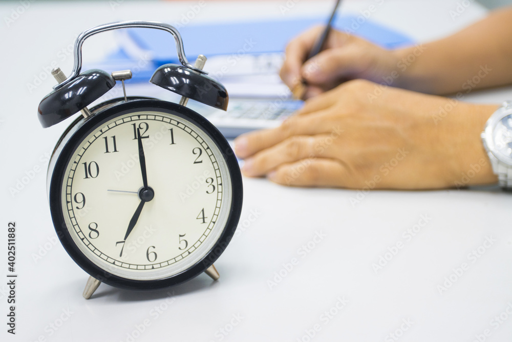 7 AM Clock on work desk in the office Time of businessman working ...