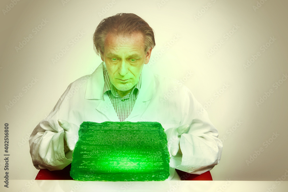 Museologist examining artifact of emerald tablet on his workplace Stock ...