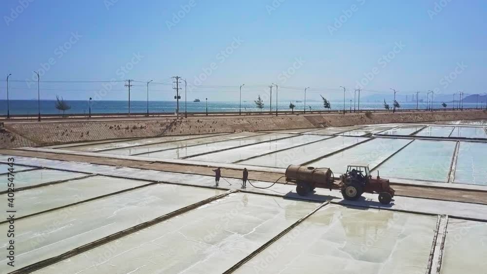 Upper view people clean evaporating salt on special ground pouring ...