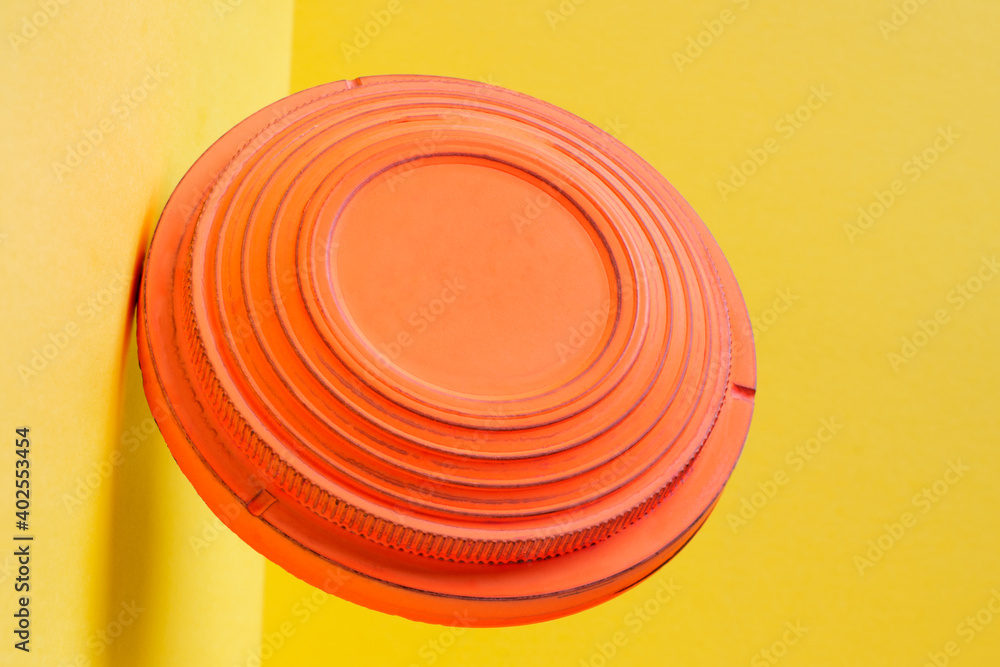 Clay disc target for skeet shooting flying against the colorful yellow ...