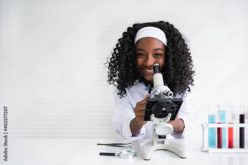 Portrait of happy African American child girl student is learning and ...