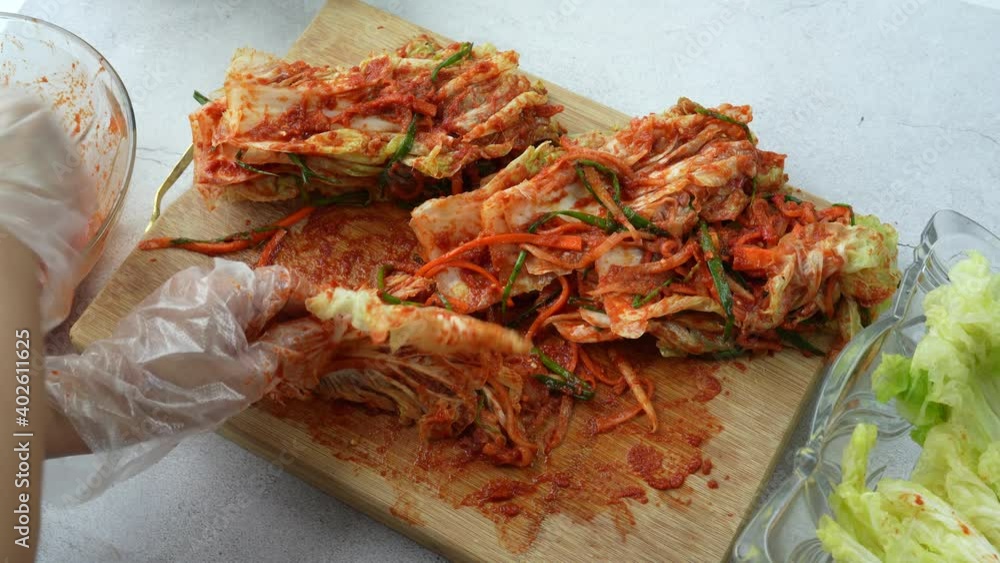 Making Korean pickles, kimchi. Woman hand mixing vegetables , kimchi ...