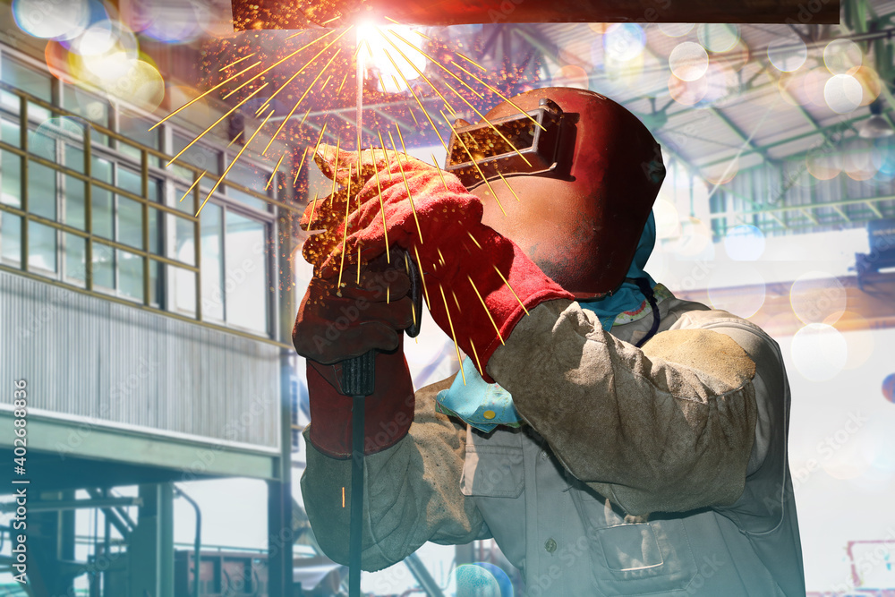 Industrial worker in factory welding process TIG with gas argon, light ...