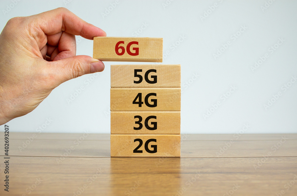 6G network evolution symbol. Hand holding a wooden block with 6g symbol ...