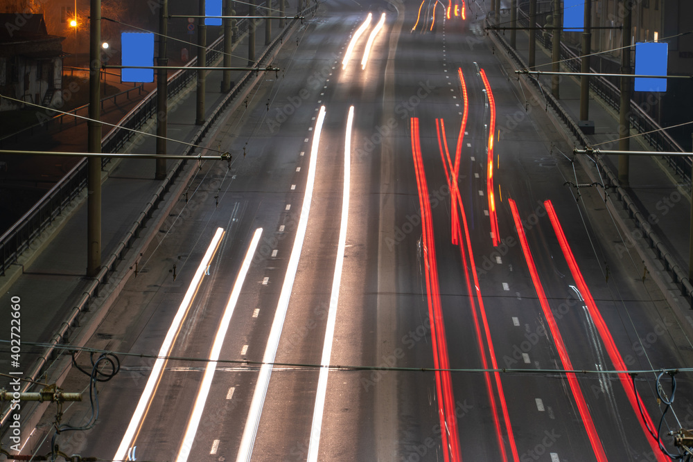 Night city. The light trails on the street. Slow shutter speed photo. A ...