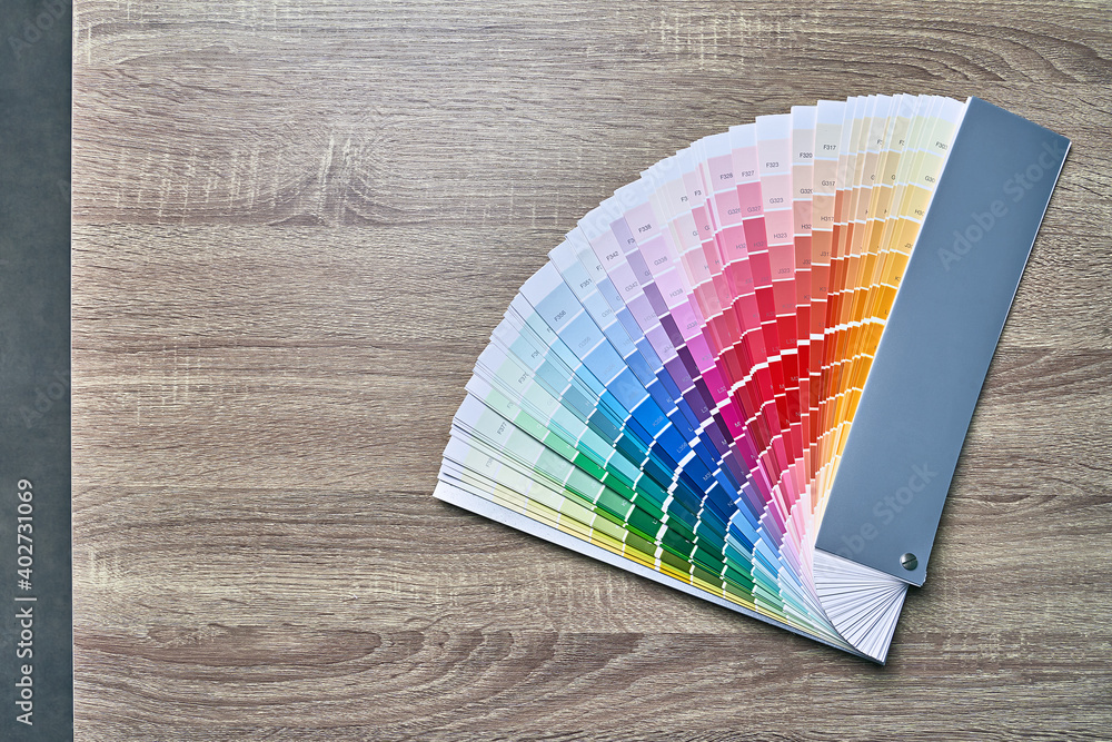 Color wheel palette for choosing paint tone. Various colors on wooden ...