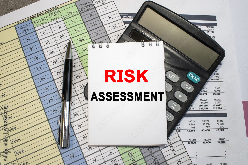 The risk assessment is written on a white sheet of notepad that lies on ...