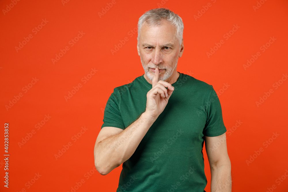 Secret elderly gray-haired mustache bearded man in basic green t-shirt ...