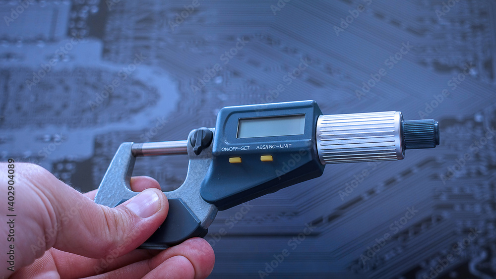 Еnegineer working with precise micrometer with digital display for ...