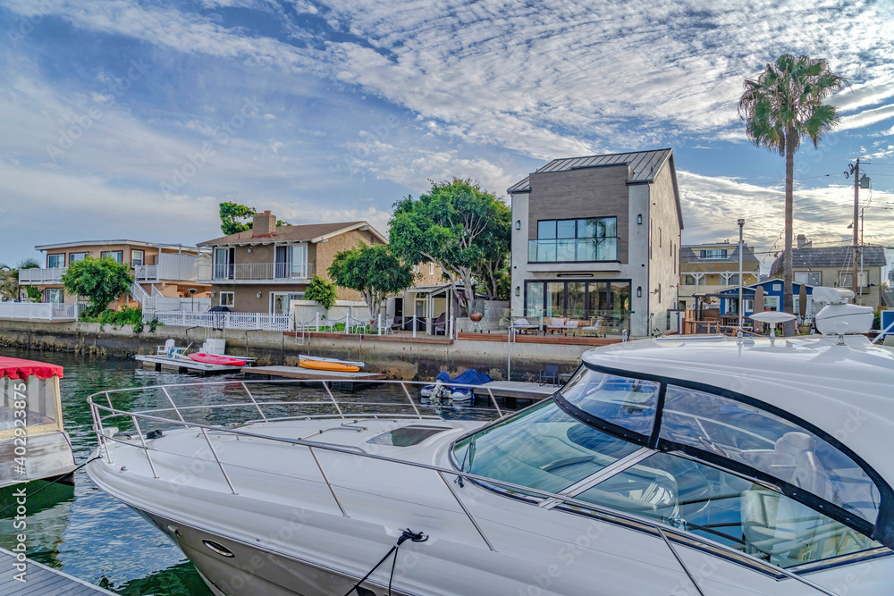 Yachts and boats along Huntington Beach harbour with waterfront homes ...