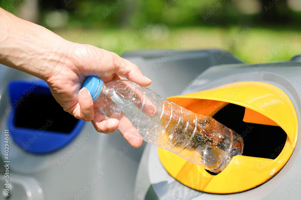 Please dispose of plastic bottle into the tank. A man throw rubbish in ...