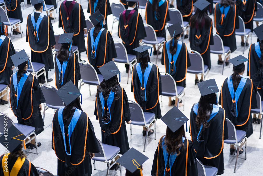 Rear view of the university graduates line up for degree award in ...