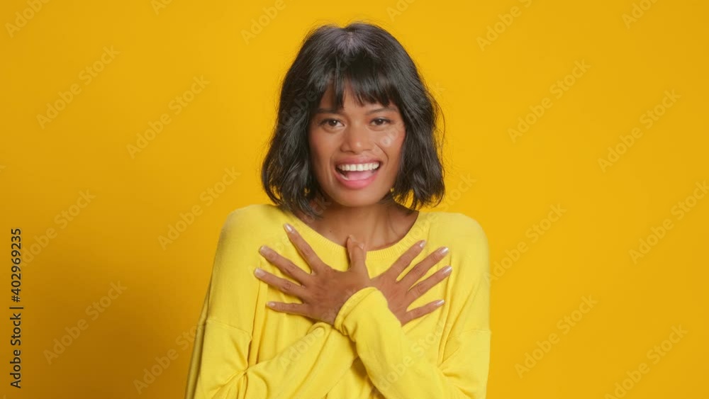 Beautiful young mixed race woman looks with surprised face expression ...