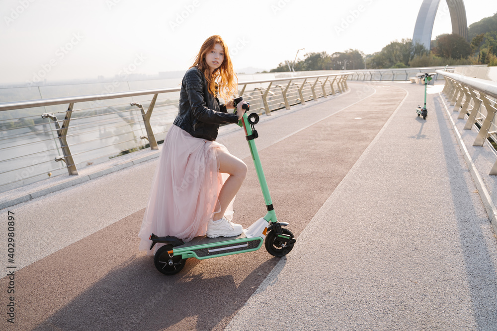 alternative eco-conscious transport in big city. Beautiful long haired ...