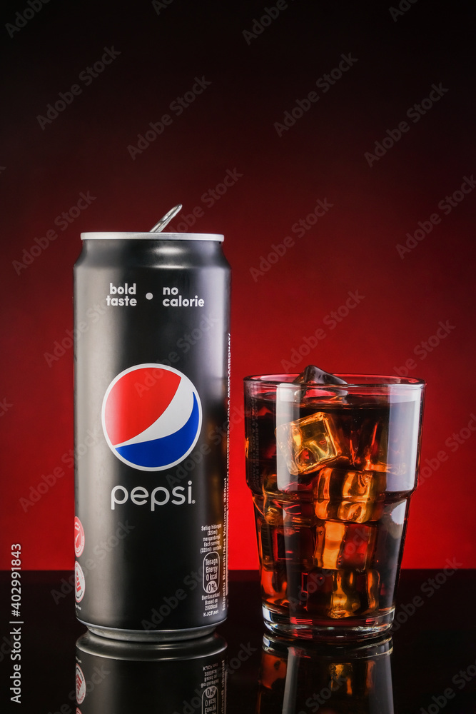Pepsi with ice cube on a dark red background. Pepsi is a carbonated ...