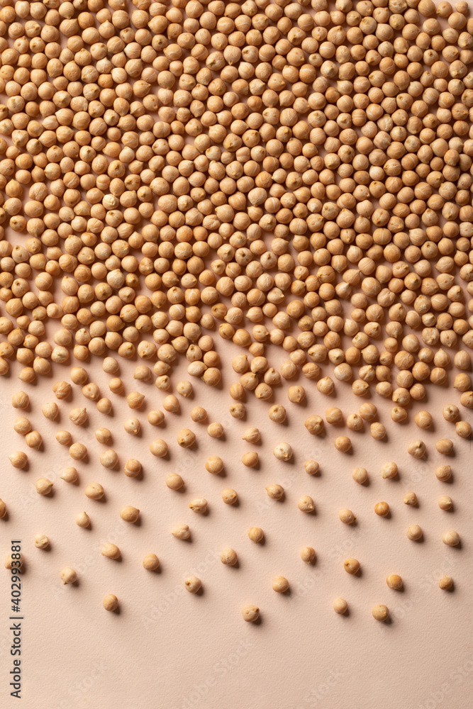 Raw chickpea seeds pile spilled beige surface, border. Natural food ...