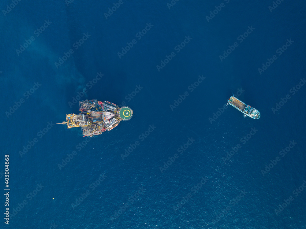 Offshore drilling rig (jack up rig) and tow vessels during the rig move ...