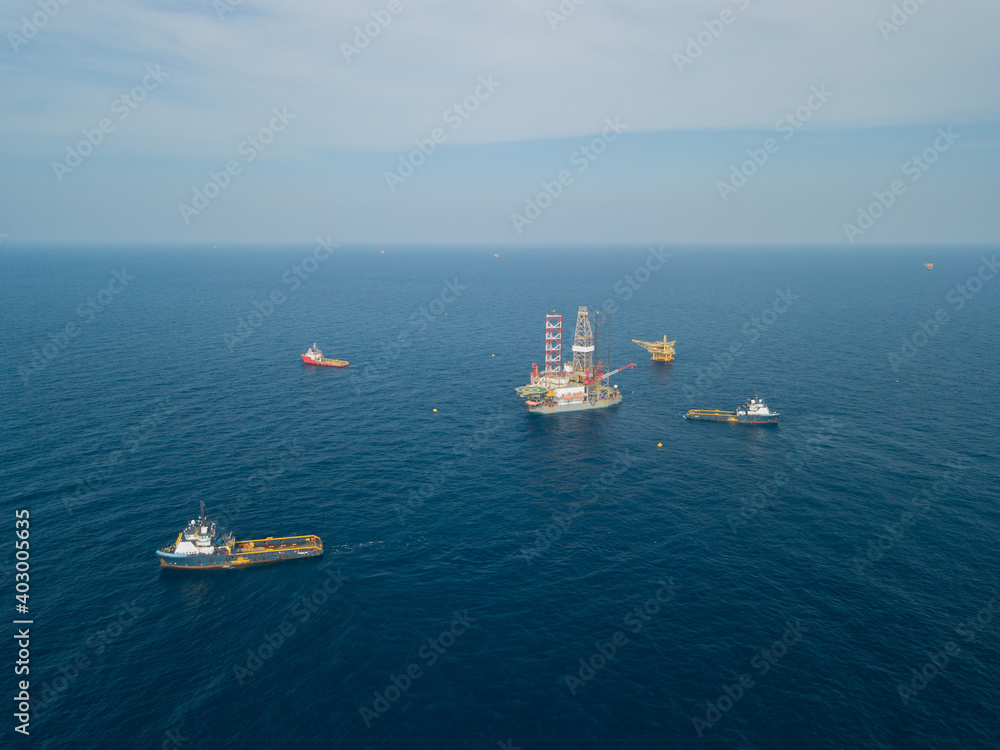 Offshore jack up rig and tow vessels during the rig move operation at ...