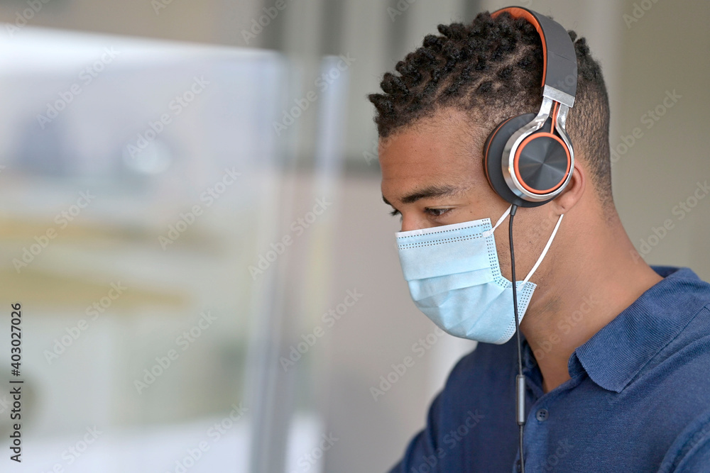 Office-worker in open-space office protected by plexiglas, wearing ...