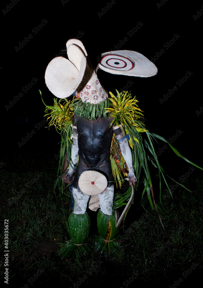 Dancer with a giant mask during a Baining tribe fire dance, East New ...