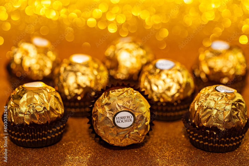 Ferrero Rocher premium chocolates on golden glitter background Stock ...