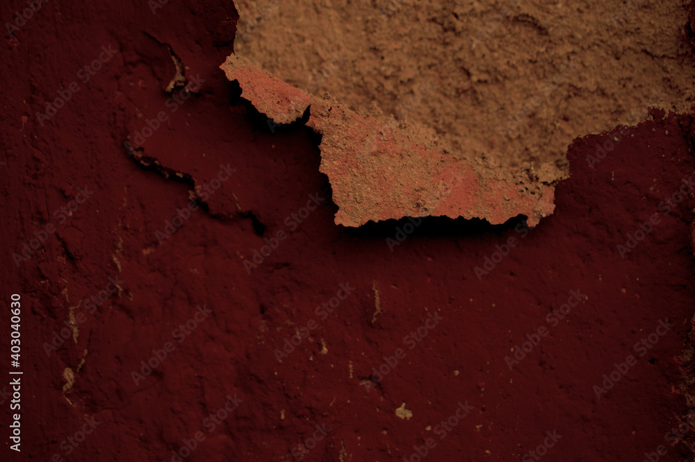 Detail of flaking plaster on a dark red wall with side vignette for ...