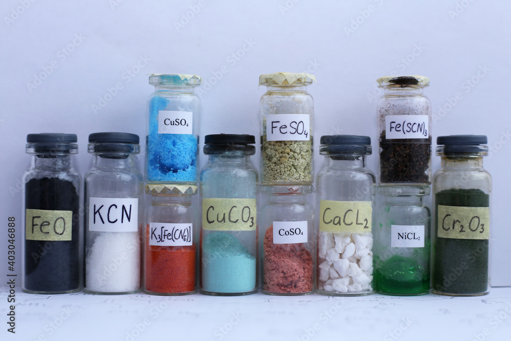 Glass jars with different colored inorganic reagents, with chemical ...