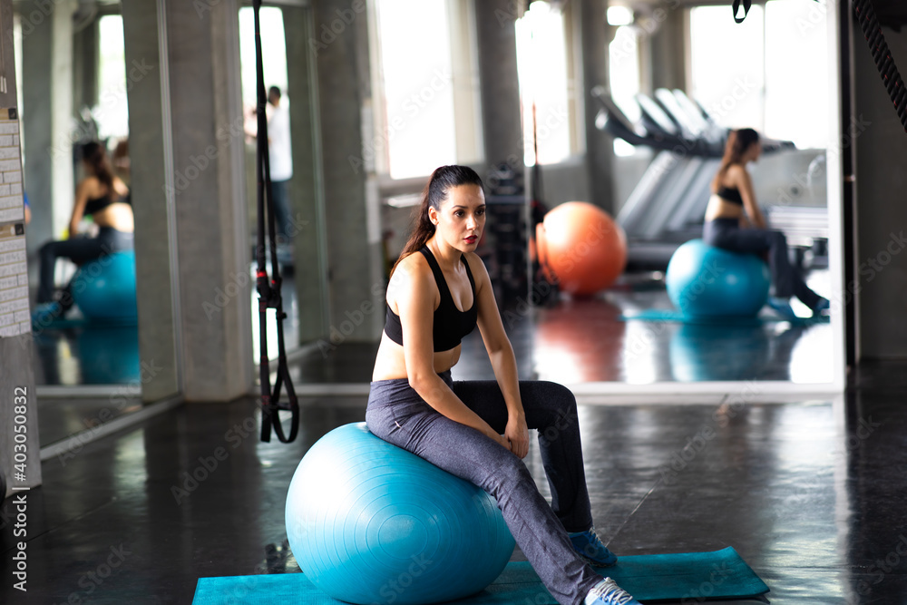 Female athlete taking rest after exercising at gym. Fitness Healthy ...