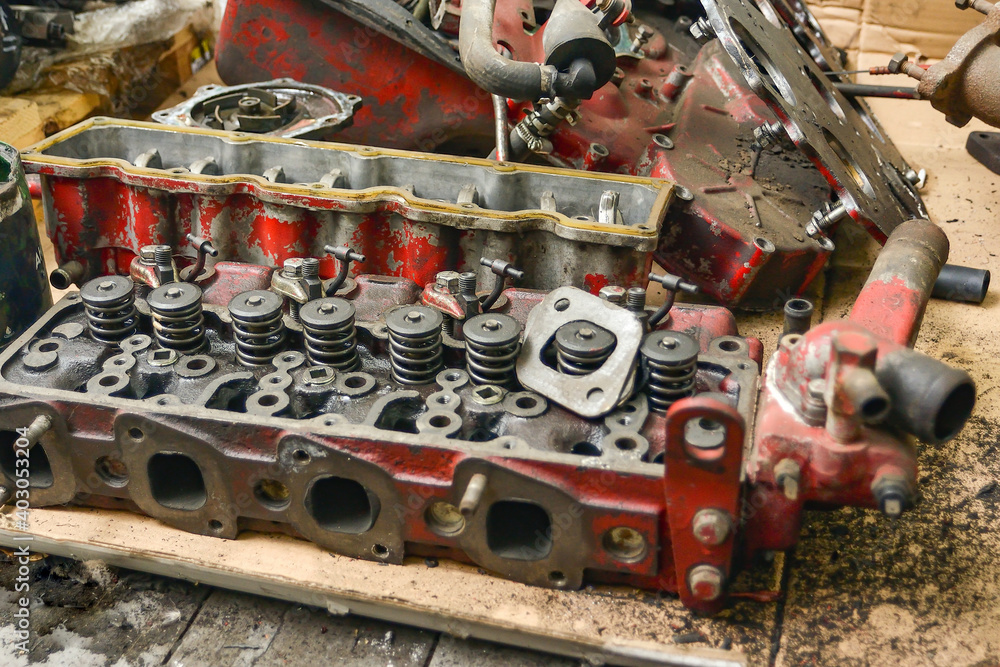Exploded view of the cylinder head of a four-cylinder engine being ...