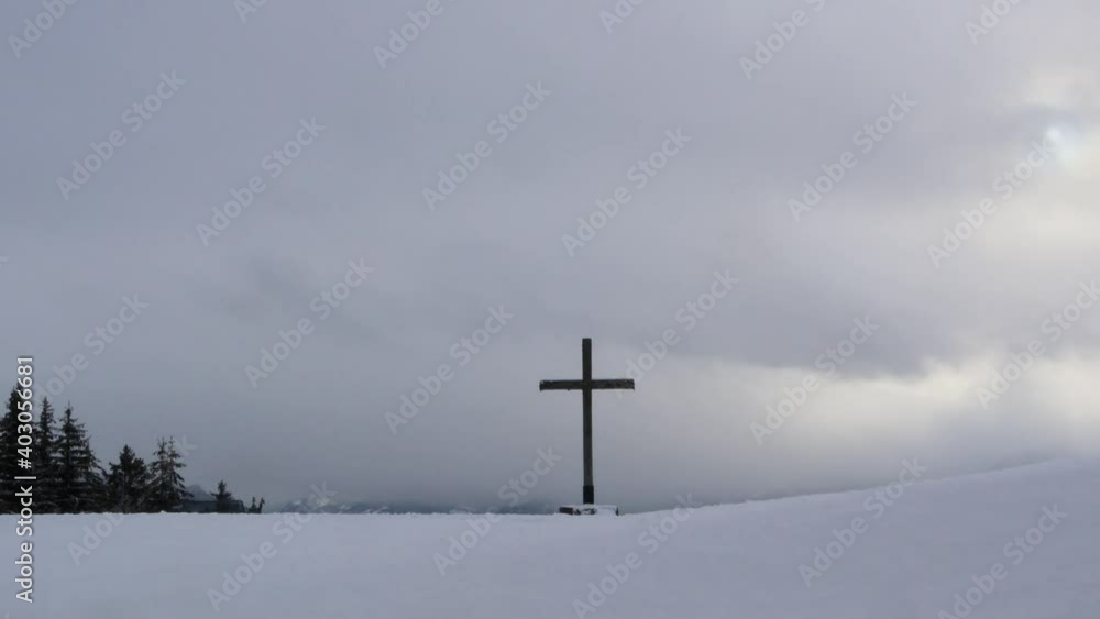 Cross in the snow. Wooden cross in snow above the dramatic sky with ...